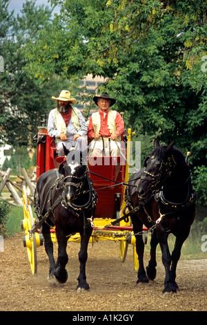 Horse drawn red stagecoach with yellow wheels Stock Photo - Alamy