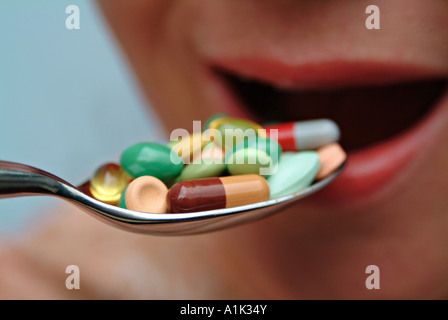 Spoon with different colorful pills on white background Stock Photo - Alamy