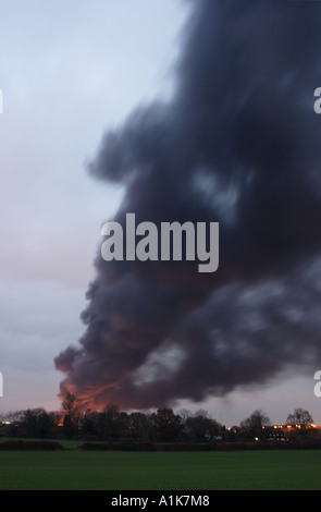 Smoke from the Buncefield oil depot explosion hangs over the town of ...