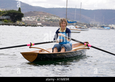 Rowing in a sleek modern designed rowing skiff Stock Photo - Alamy