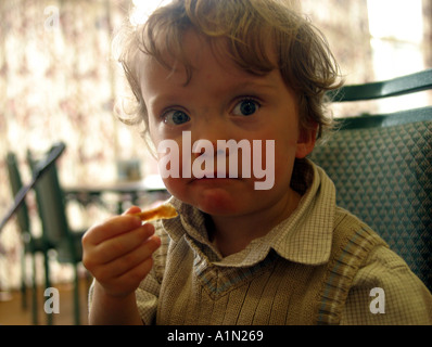 Lewis aged two eating his lunch in a cafe Stock Photo - Alamy
