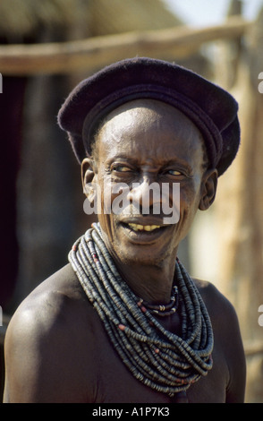 A chief of an indigenous Himba people tribe and his wife are posing in ...