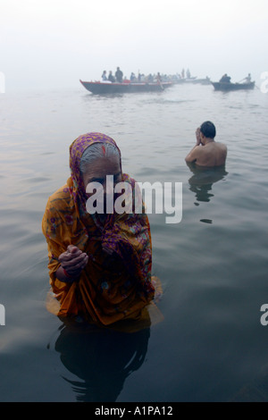 A Hindu man takes a holy bath before praying during Shivratri festival ...
