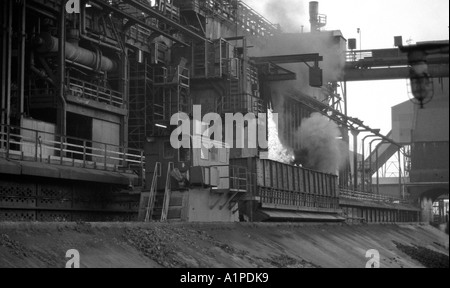 Coke being pushed from a coke oven and caught in a coke quenching car ...