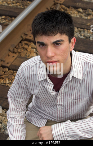 Young man on railroad tracks Stock Photo - Alamy