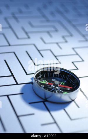 Compass on maze Stock Photo - Alamy