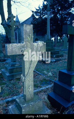 gravestone in atmospheric cemetery with blue cast Stock Photo - Alamy