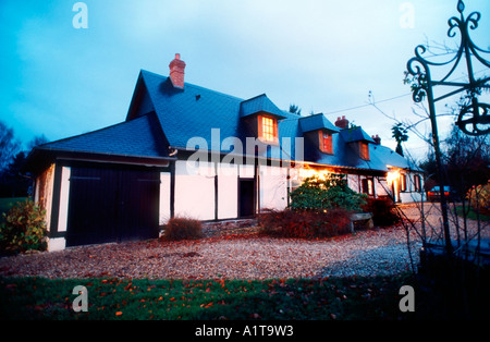 Exterior view of a French country cottage, Berrien, Normandy - John ...
