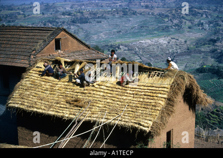 Roofers working on roof framework of old church with copper tower on ...