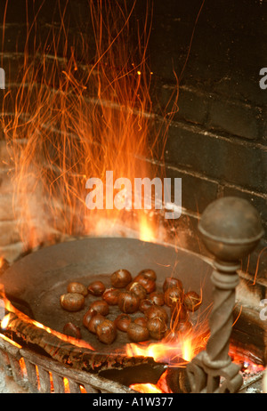 Roasting chestnuts on fire in iron stove, Portuguese street food in ...