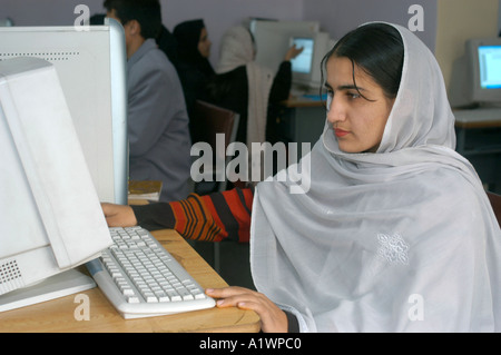 Woman learning computer skills in a classroom setting Stock Photo - Alamy