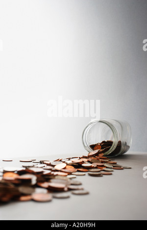 Coin Jar On It's Side Spilling Money Stock Photo - Alamy