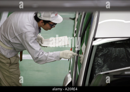 A Toyota Prius hybrid car undergoes inspection on the production line ...