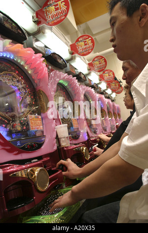Japanese gamblers playing the popular Pachinko gambling machines in ...