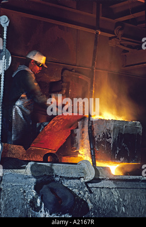 Worker checks molten iron in foundry Stock Photo - Alamy