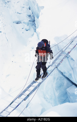 Crossing a crevasse on Mount Everest in the Khumbu Icefall Stock Photo ...