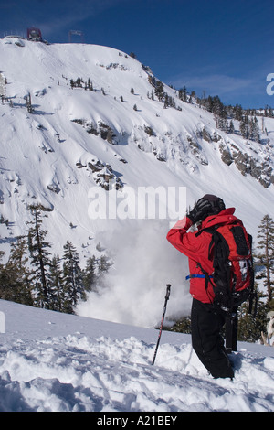 A ski patroller throwing explosives for avalanche control at Squaw ...