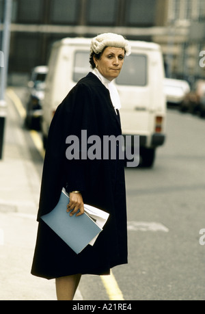 London, England, UK. Female barrister carrying a cup of coffee outside ...