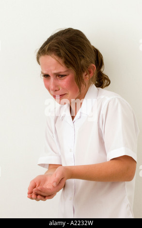 Girl holding out hand for smack and crying Stock Photo - Alamy