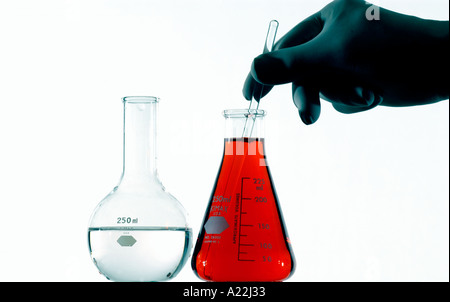 hand with two beakers in lab Stock Photo - Alamy