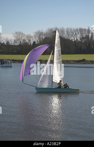 Two person sailing dinghy with jib, main sail and spinnaker River Deben ...