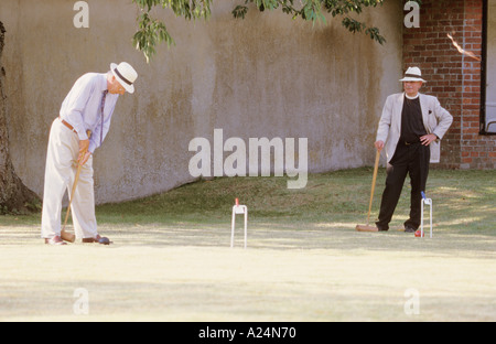 Croquet game players in Victorian Dress Lawn Grass Hoop Ball Mallet Man ...