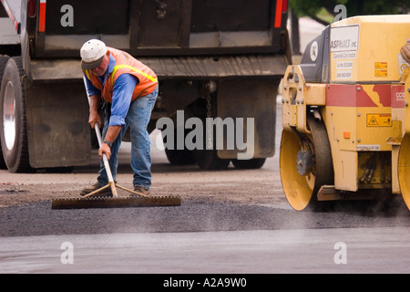 Road worker raking hot asphalt Stock Photo - Alamy