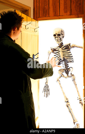Skeleton opening door Stock Photo - Alamy