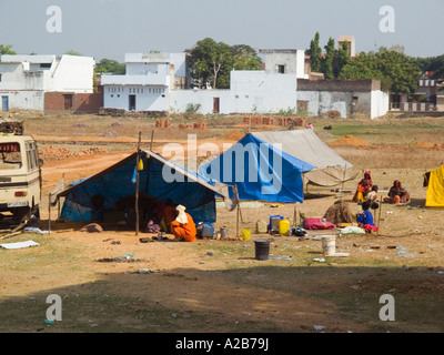 Lower class family sitting on the steps of a manor house in the ...
