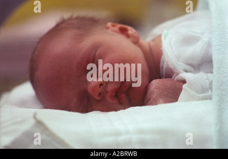 Newborn baby lying on its back crying Stock Photo - Alamy