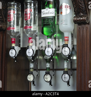 row of alcoholic spirits and bar optics in a bar pub in ireland Stock ...