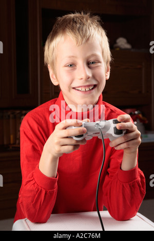 portrait of a young boy playing playstation Stock Photo - Alamy