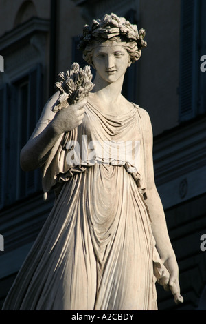 Elegant marble statue of a young woman with flowers in Piazza del Stock ...