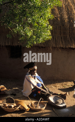 Zulu married woman wearing a traditional hat grinding maize Kwazulu ...