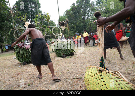 Men throw shell money at Tubuans at a Tolai Death Ceremony, Matupit ...