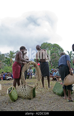 Tolai men distributing shell money for use in a Tolai Death Ceremony ...