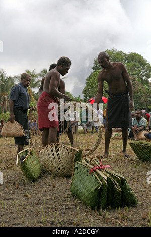 Tolai men distributing shell money for use in a Tolai Death Ceremony ...