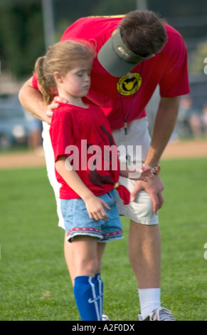Coach comforting crying soccer player age 35 and 6 after a sports ...