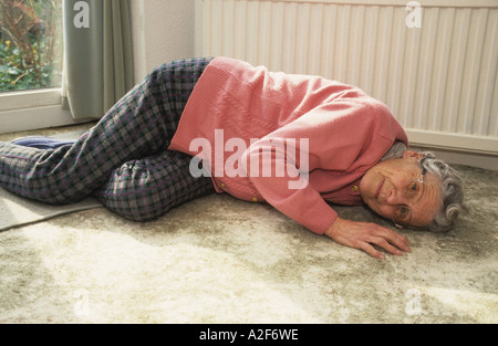 elderly woman fallen over or collapsed on floor with concerned dogs ...