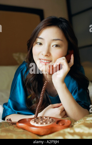 Smiling woman talk on landline phone with support Stock Photo - Alamy