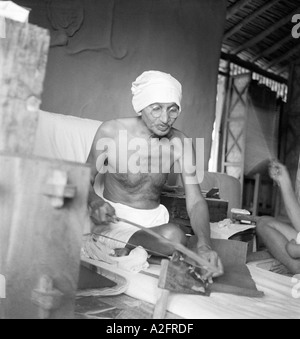 Mohandas Karamchand Gandhi spinning cloth in 1940. Gandhi (2 October ...