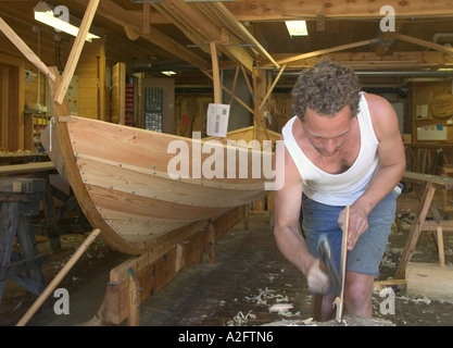 A traditional lapstrake rowboat being built with traditional ...