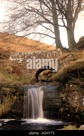 Three Shire Heads. A waterfall and packhorse stone bridge at Three ...