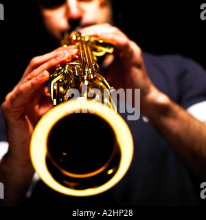Square shot of man playing soprano on a black background with blured ...