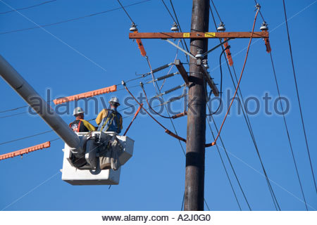 Electrical line workers use an elevated work platform called a Stock ...