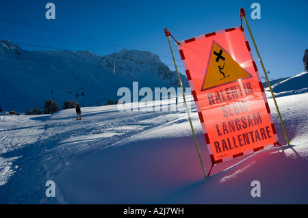 Slow sign for skiers crossing a ski tow track in the alps Stock Photo ...
