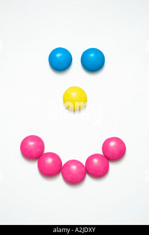 Colourful sweets forming smiley face on black background Stock Photo ...