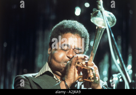 American jazz musician Dizzy Gillespie puffing out his cheeks during a ...