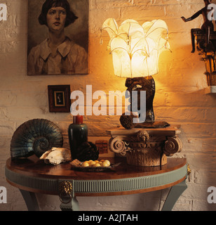 Large picture above lighted wall light above staircase Stock Photo - Alamy