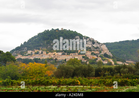 The Seguret village clinging to the hillside, viewed over a vineyard ...